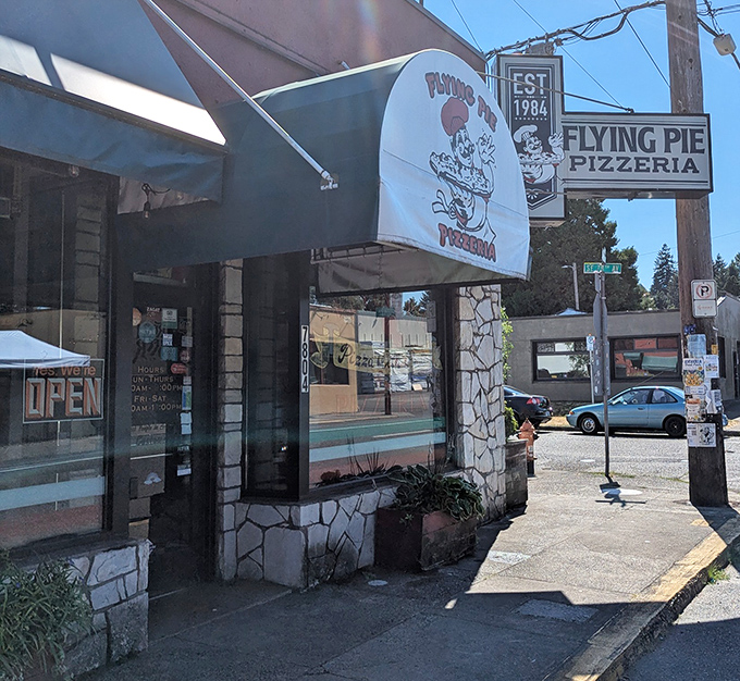 That stone-accented storefront with the playful awning? It's where Portland pizza dreams come true, one slice at a time.