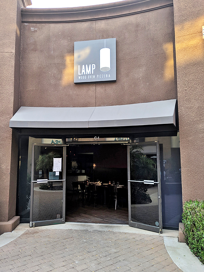 The sleek entrance to LAMP invites you into a world where pizza becomes art and every bite tells a delicious story.