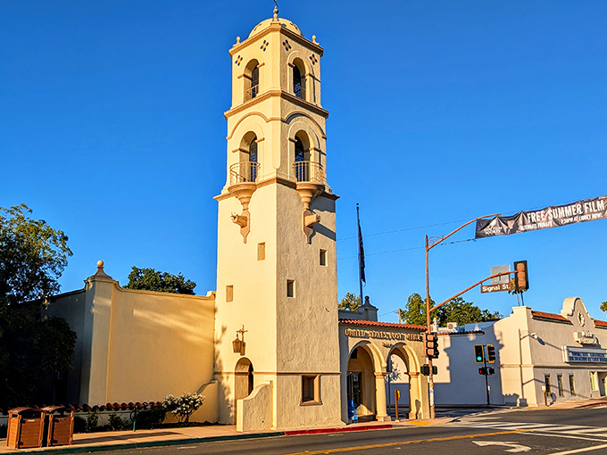The iconic bell tower of Ojai stands tall against a brilliant blue sky, a landmark that has witnessed decades of small-town life.