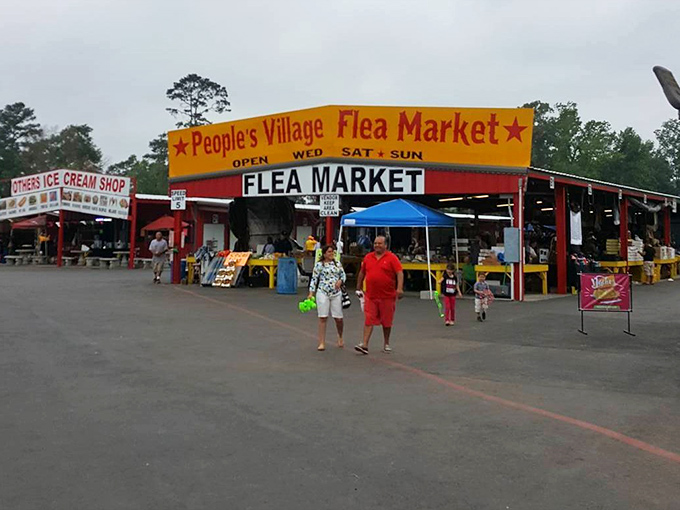 People's Village Flea Market welcomes shoppers with its cheerful red exterior—a beacon for bargain hunters in East Texas.