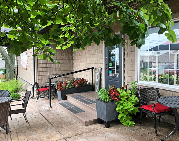 Lush greenery frames the entrance to Rebecca's Bistro. A peaceful patio where time slows down and appetites ramp up.