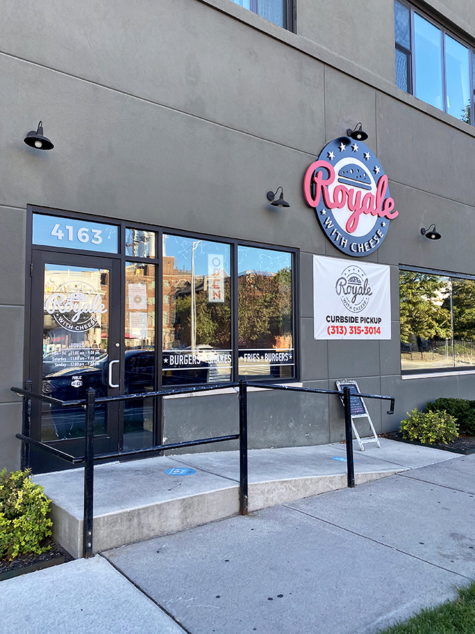 Even in daylight, Royale with Cheese maintains its cool factor. That neon sign isn't just clever&mdash;it's a promise of movie-worthy burger experiences.