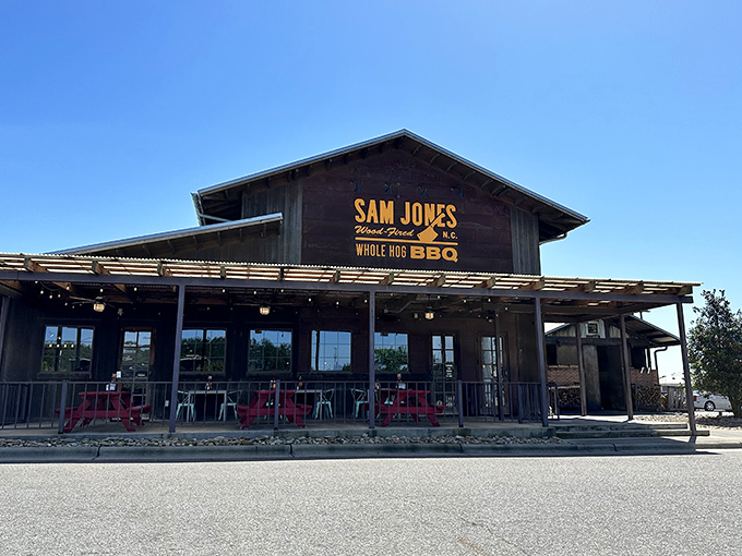 The covered porch at Sam Jones invites you to sit a spell with some whole hog barbecue. Those pink chairs are saying "stay awhile, the pork's worth it."