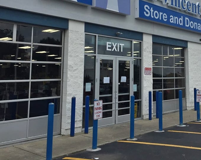 The large glass exit of St. Vincent de Paul sends bargain hunters back into the world, arms full of pre-loved possibilities.