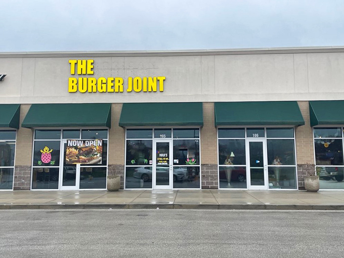 Daytime reveals The Burger Joint's clean lines and inviting entrance. The "Now Open" sign still proudly displayed for this popular burger destination.
