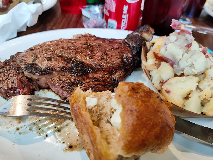 A 10-ounce ribeye keeping excellent company with garlic potatoes and rolls worth writing home about.