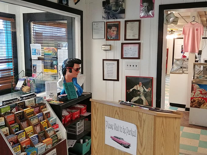 Elvis memorabilia watches over diners like a rockabilly guardian angel. "Please Wait To Be Seated" is the diner's gentle commandment.