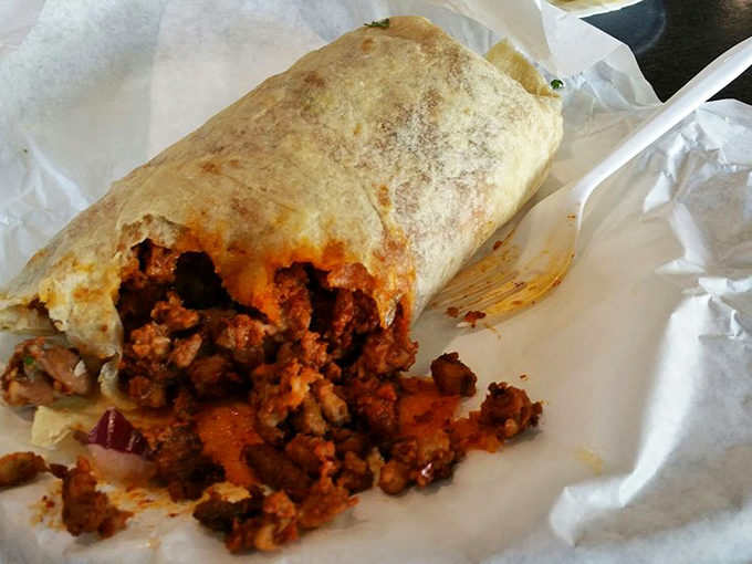 This burrito isn't just food, it's an engineering marvel—expertly wrapped and bursting with al pastor that's been kissed by fire.