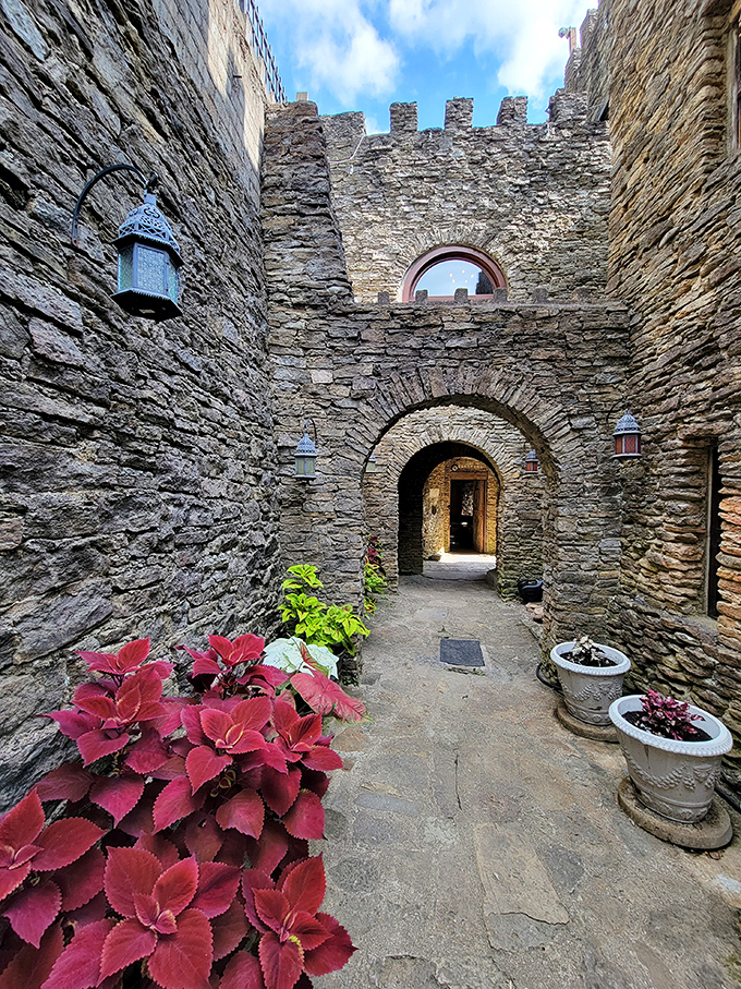 Stone pathways flanked by vibrant plants create secret passages throughout the castle grounds&mdash;just mind your head under those archways!