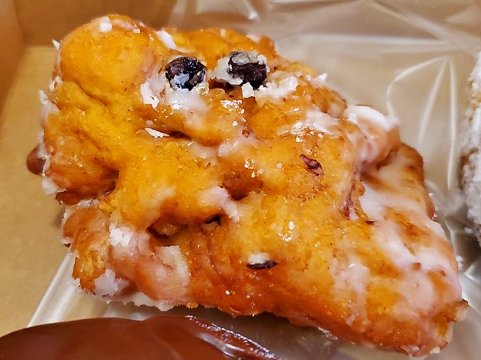 This apple fritter isn't just fried dough—it's a craggy, glazed masterpiece with pockets of cinnamon-apple goodness hiding in every nook and cranny.