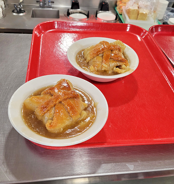 Apple dumplings lounging in a pool of cinnamon-spiced glory &ndash; like little edible presents waiting to be unwrapped by your eager fork.