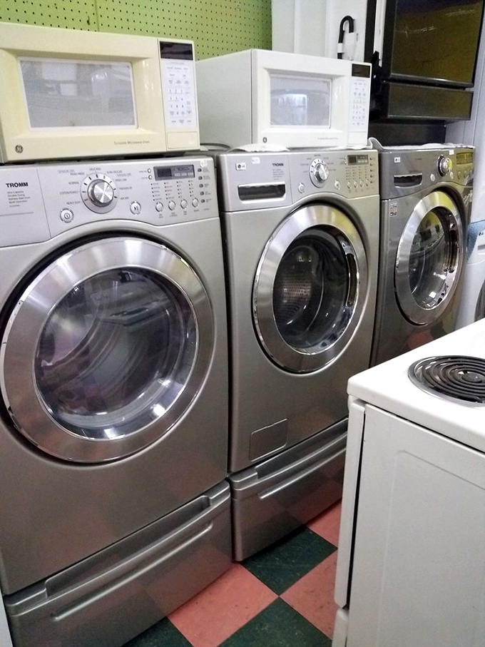 The appliance graveyard where washing machines get their second chance. That avocado-colored microwave might just be retro enough to be cool again.