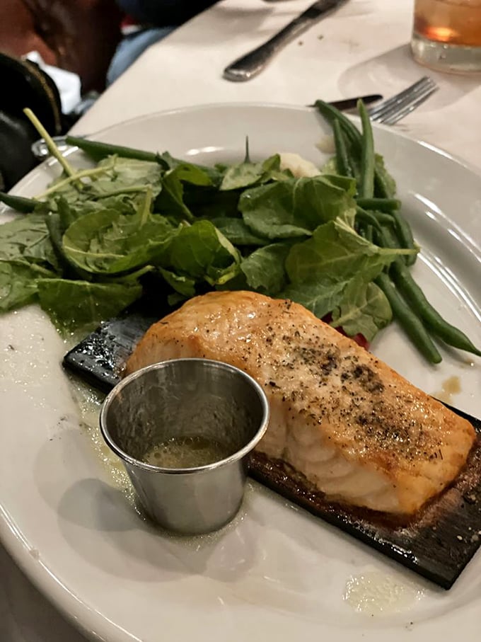 Cedar-planked salmon – nature's perfect vessel for delivering flaky, herb-kissed fish straight to your eager fork.