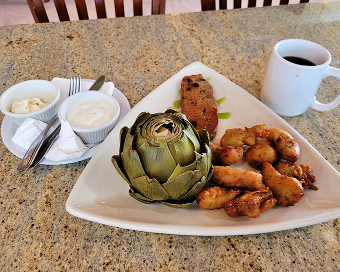 The royal treatment: A whole steamed artichoke holds court alongside its fried cousins. The dipping sauces stand ready for their supporting role in this veggie drama.