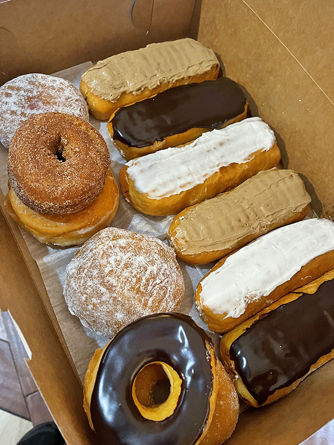 A cardboard ark of pastry perfection. These donuts aren't just fried dough&mdash;they're little rings of joy waiting to make your day exponentially better.