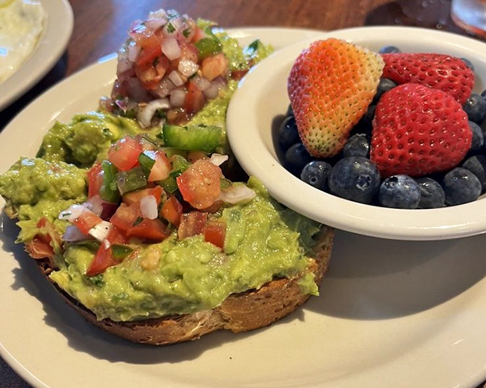 Avocado toast with fresh fruit that makes you forget all those jokes about millennials spending their mortgage money on breakfast.