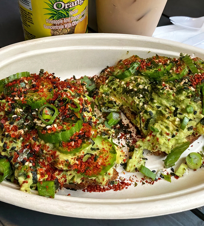 Avocado toast gets the island treatment with vibrant chili flakes and furikake—breakfast reinvented with a punch of umami that wakes up your morning.