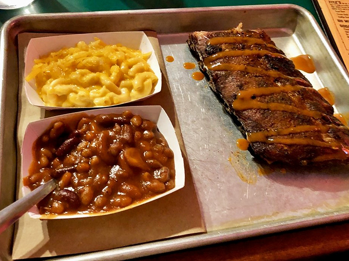 A tray of barbecue bliss that proves good things come in threes: ribs, mac and cheese, and beans that deserve their own fan club.