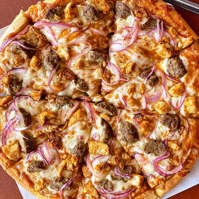 BBQ chicken pizza with those perfect red onion crescents&mdash;proof that sometimes breaking tradition leads to delicious rebellion.