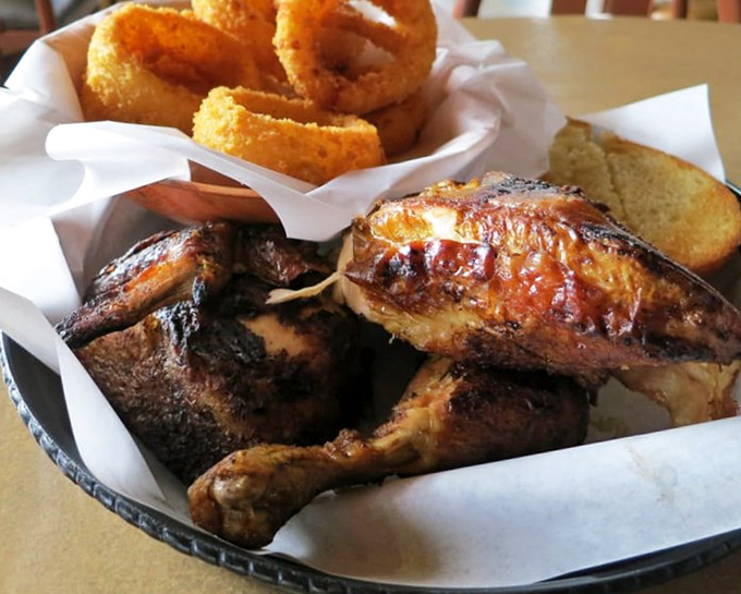 BBQ chicken dinner with onion rings that could make a vegetarian reconsider their life choices. The char marks tell you everything you need to know.