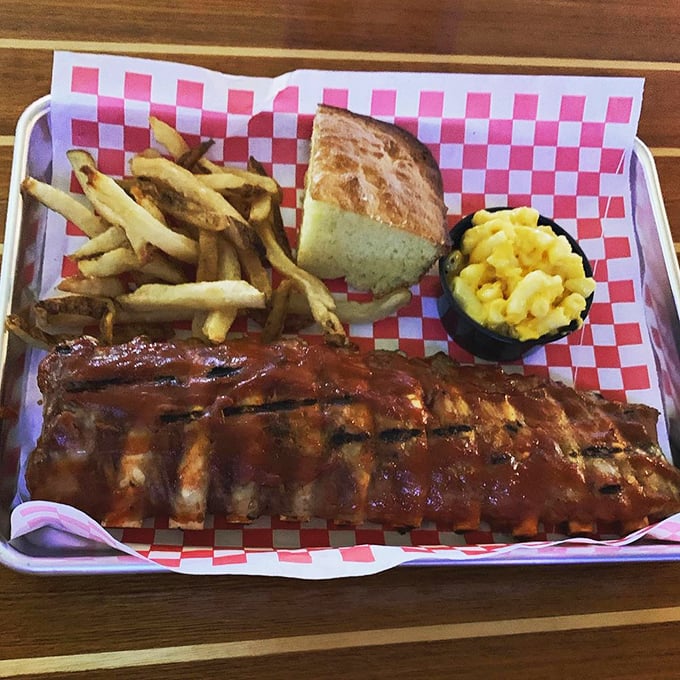 Baby back ribs lounging on a red-checkered runway, ready for their moment of glory before disappearing forever.