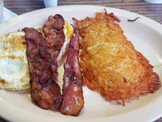 The holy trinity of breakfast: perfectly fried eggs, bacon with the ideal crisp-to-chew ratio, and hash browns that deserve their own fan club.