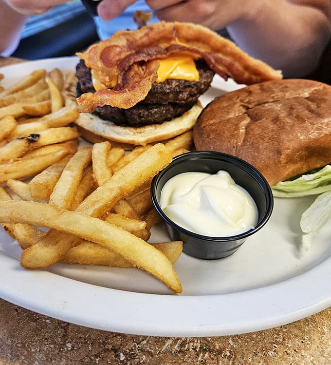 The star attraction&mdash;a bacon cheeseburger with perfectly melted cheese and bacon strips playing the role they were born for.