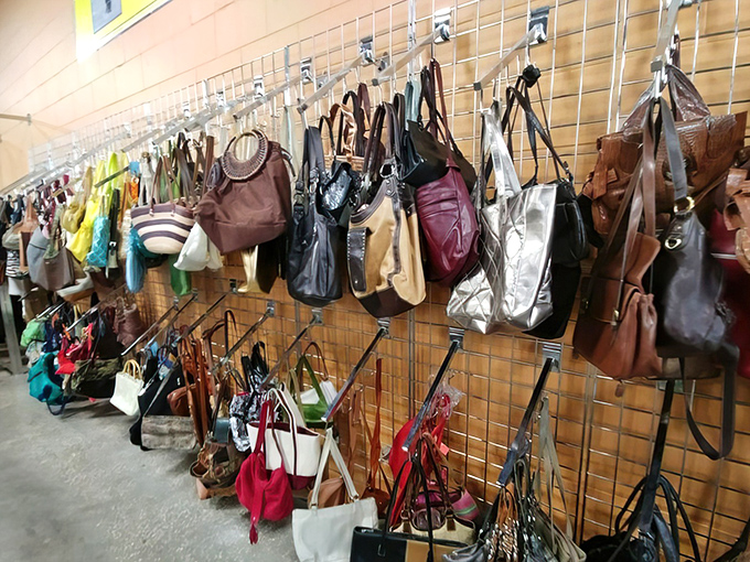 Handbag heaven! A leather lover's paradise where yesterday's splurges become today's steals, hanging like fashionable fruit ripe for picking.