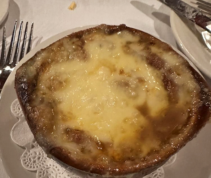 French onion soup that's worth the cheese pull. That golden, bubbling canopy of cheese is hiding a rich, beefy treasure underneath.