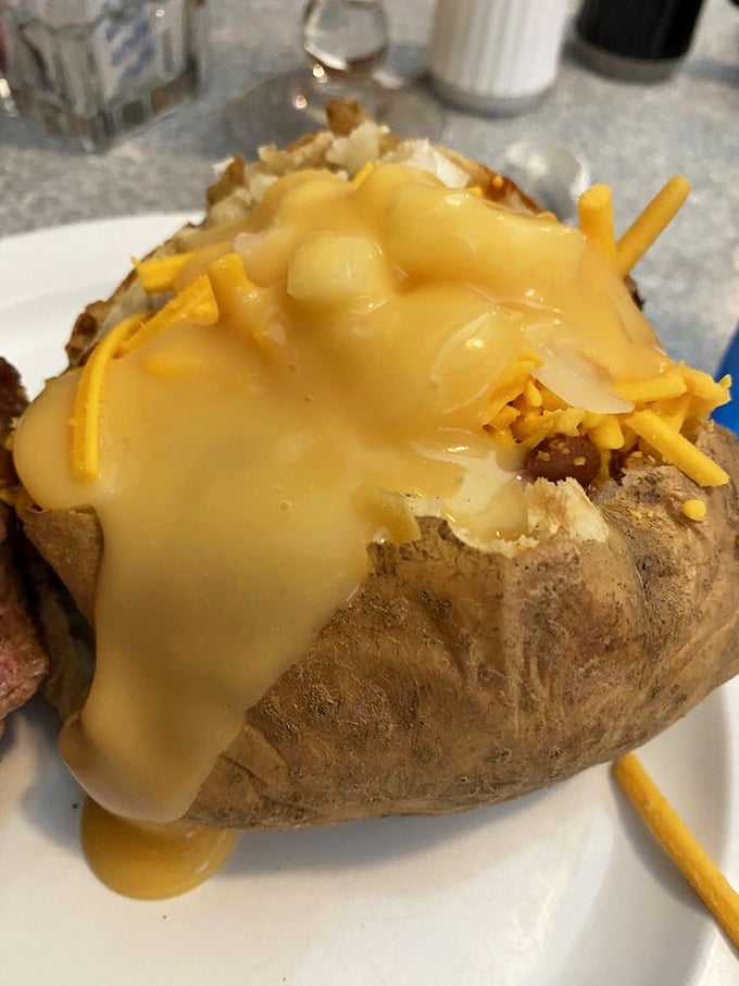 This loaded baked potato isn't just a side dish &ndash; it's practically wearing a cheese tuxedo to your mouth's formal dinner party.