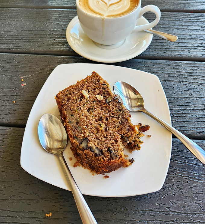 This slice of banana bread alongside artfully poured coffee isn't just breakfast—it's therapy on a plate, moist and rich enough to make your grandmother jealous.