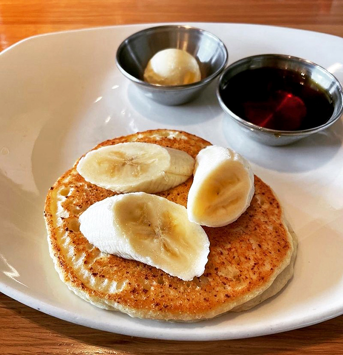 A pancake so perfectly golden it belongs in Fort Knox, topped with bananas that didn't sacrifice their lives in vain.
