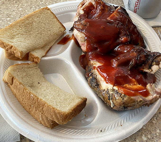 The perfect barbecue plate: meat glistening with sauce, cornbread that crumbles just right, and green beans that actually taste like vegetables.