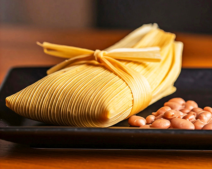 The traditional wrapped tamale gets a stylish presentation alongside beans – like comfort food dressed for a night out.