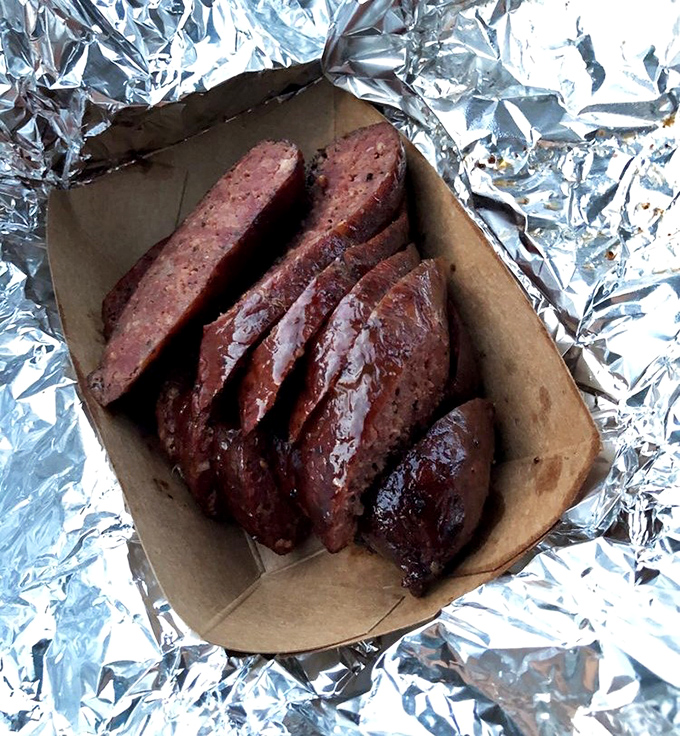 That perfect snap when you bite into properly smoked sausage is pure barbecue bliss.