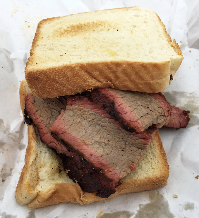 A proper brisket sandwich is poetry between bread. This one has that bark-to-meat ratio that would make a Texan tip their hat.