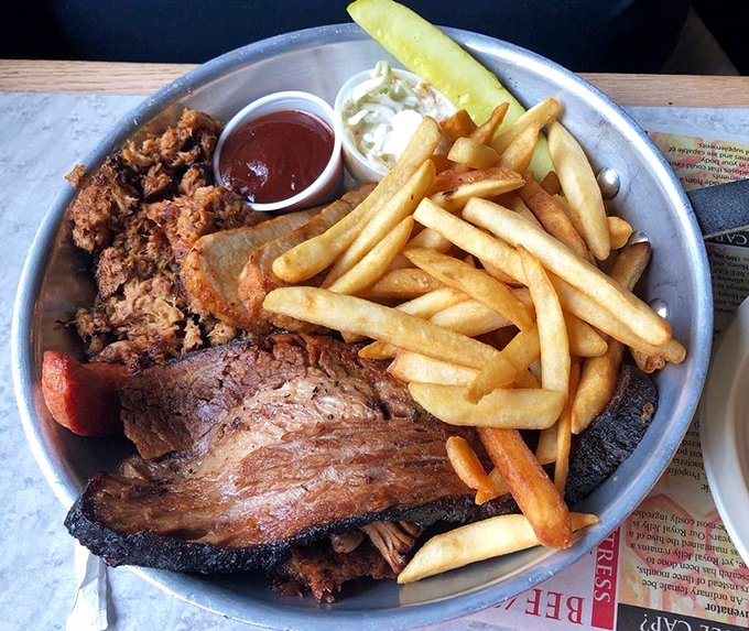 Beef brisket with a smoke ring so perfect it could make a pitmaster weep, served with fries that clearly didn't come from a freezer.