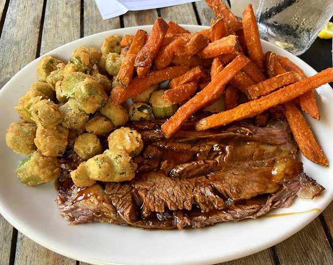 Brisket, fried okra, and sweet potato fries&mdash;the holy trinity of comfort that makes you want to hug the pitmaster responsible for this plate.