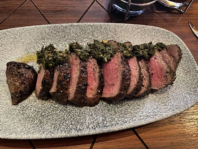 This sirloin, with its herb garnish, isn't just dinner&mdash;it's a reminder that sometimes the simplest pleasures are worth crossing town for.