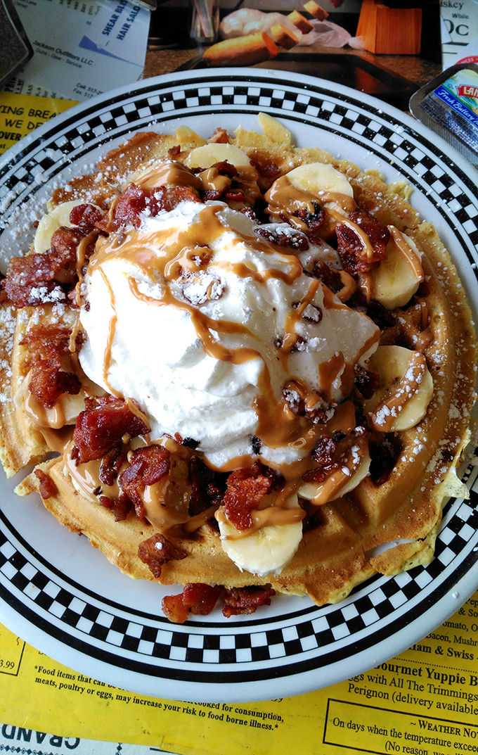 This isn't just a waffle&mdash;it's a platform for culinary creativity. Bananas, bacon, whipped cream, and nuts create a breakfast carnival that would make Elvis weep.