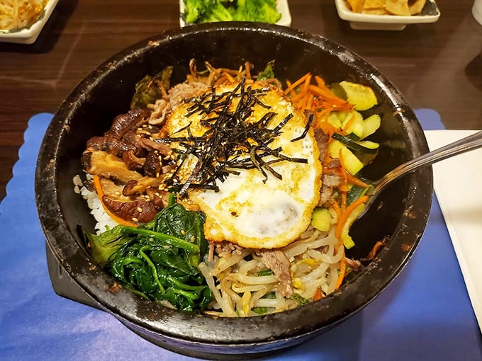 Bibimbap: Korea's answer to "everything but the kitchen sink" &ndash; a beautiful chaos of vegetables, meat, rice, and that perfect sunny-side-up egg crown.
