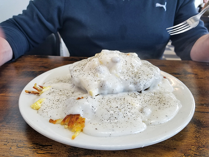 Biscuits and gravy&mdash;the breakfast that hugs you from the inside. This plate isn't just food; it's emotional support with pepper.