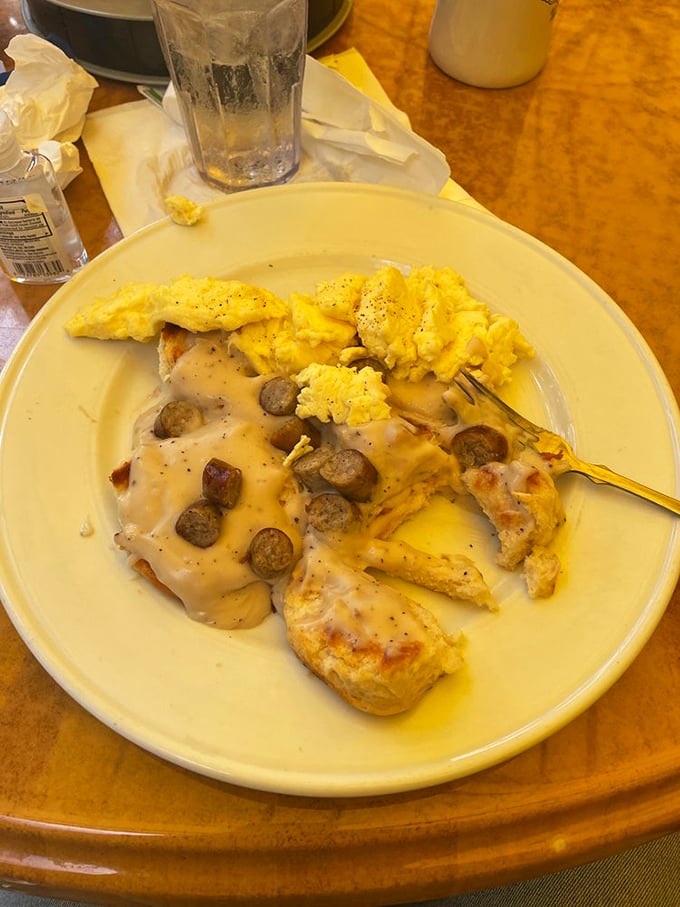 Breakfast drama at its finest&mdash;fluffy biscuits drowning in creamy sausage gravy with scrambled eggs playing the perfect supporting role.
