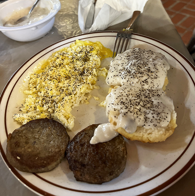 A breakfast plate that means business. Those biscuits aren't just smothered in gravy—they're having a full-on spa treatment in it.