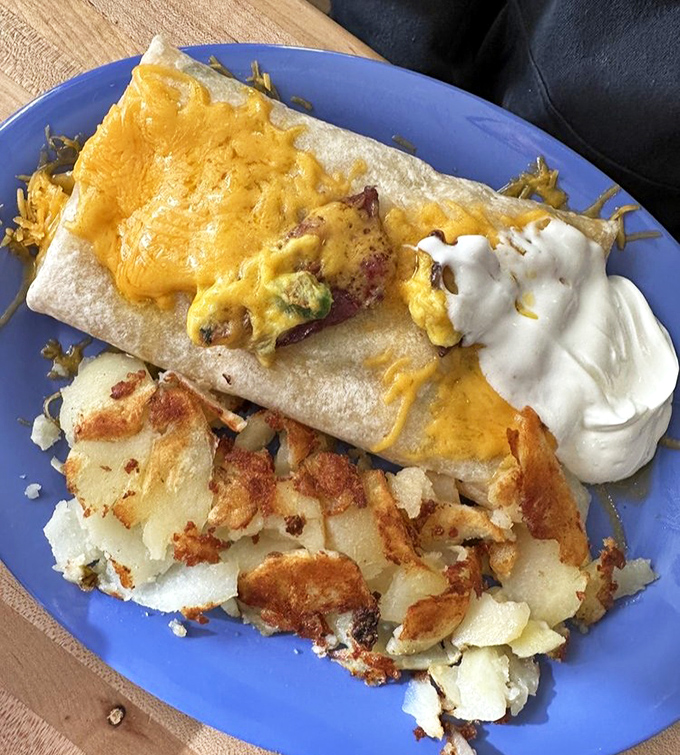 A breakfast burrito that requires both hands and a strategy. That melted cheese and crispy potato combo is the reason cameras were invented.