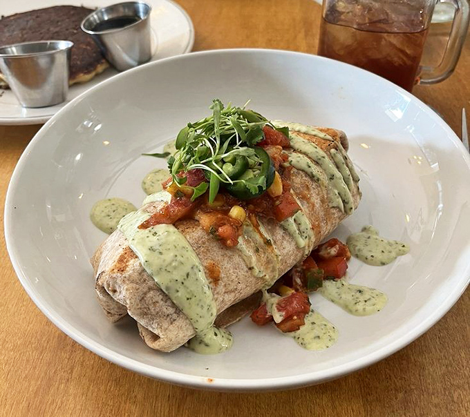 Breakfast ambition realized: a burrito bursting with fresh ingredients and drizzled with a sauce so good you'll want to bottle it and take it home. 