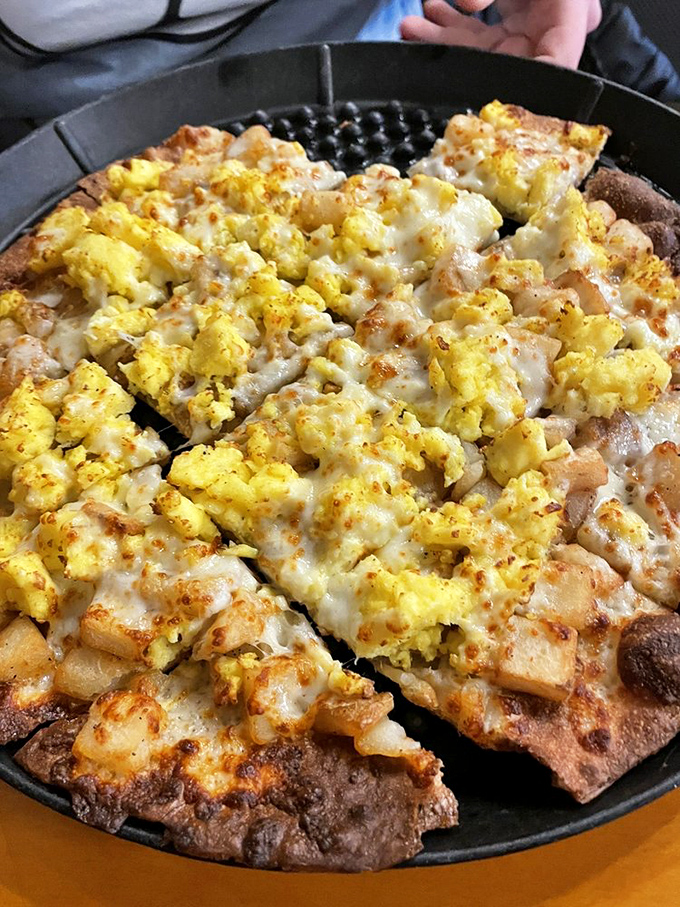 The breakfast pizza defies all logic – eggs and cheese on pizza shouldn't work this well, but One World makes breakfast rebellion taste amazing.