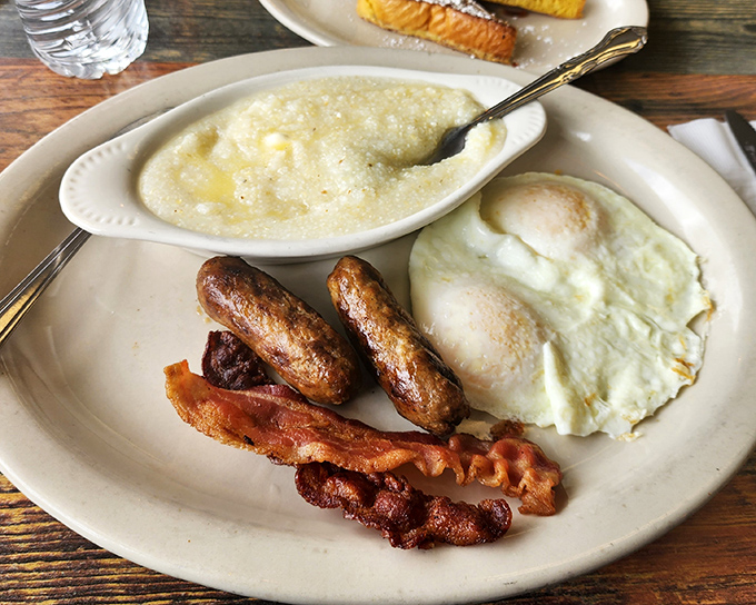 Breakfast perfection on a plate: eggs, sausage, bacon, and grits that would make a Southerner nod in solemn approval.