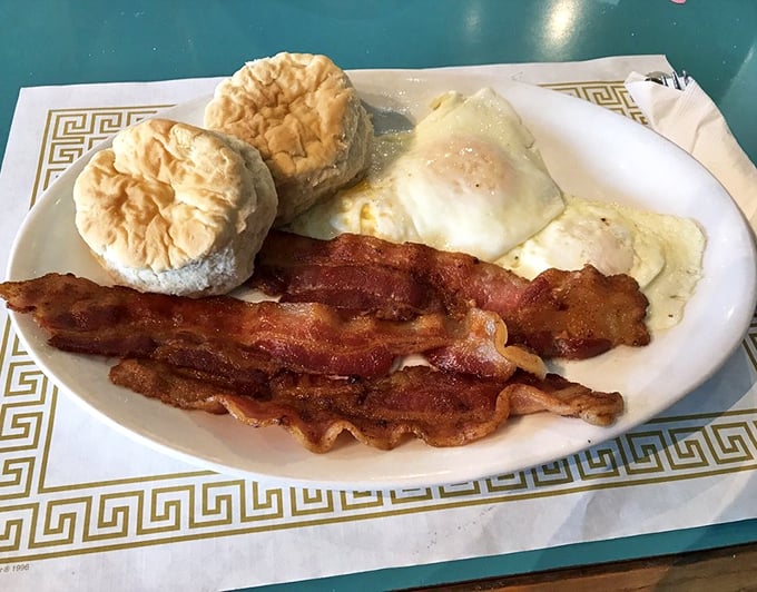 The holy trinity of breakfast: perfectly cooked eggs, bacon with the ideal bend-before-break ratio, and biscuits that would make your grandmother question her recipe.