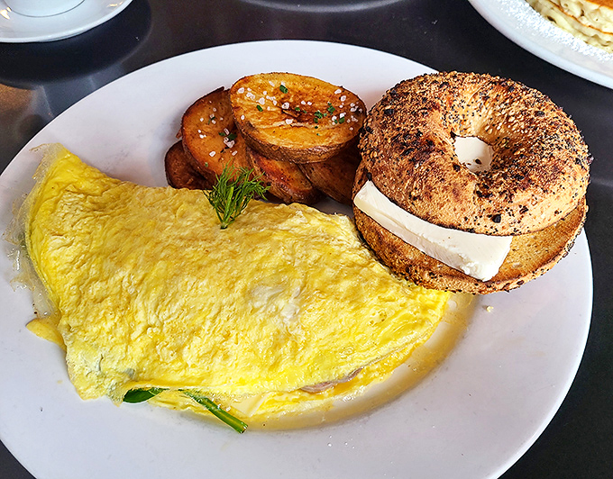 The holy trinity of breakfast: a perfectly folded omelet, golden home fries, and an everything bagel. Simple? Yes. Ordinary? Not even close.
